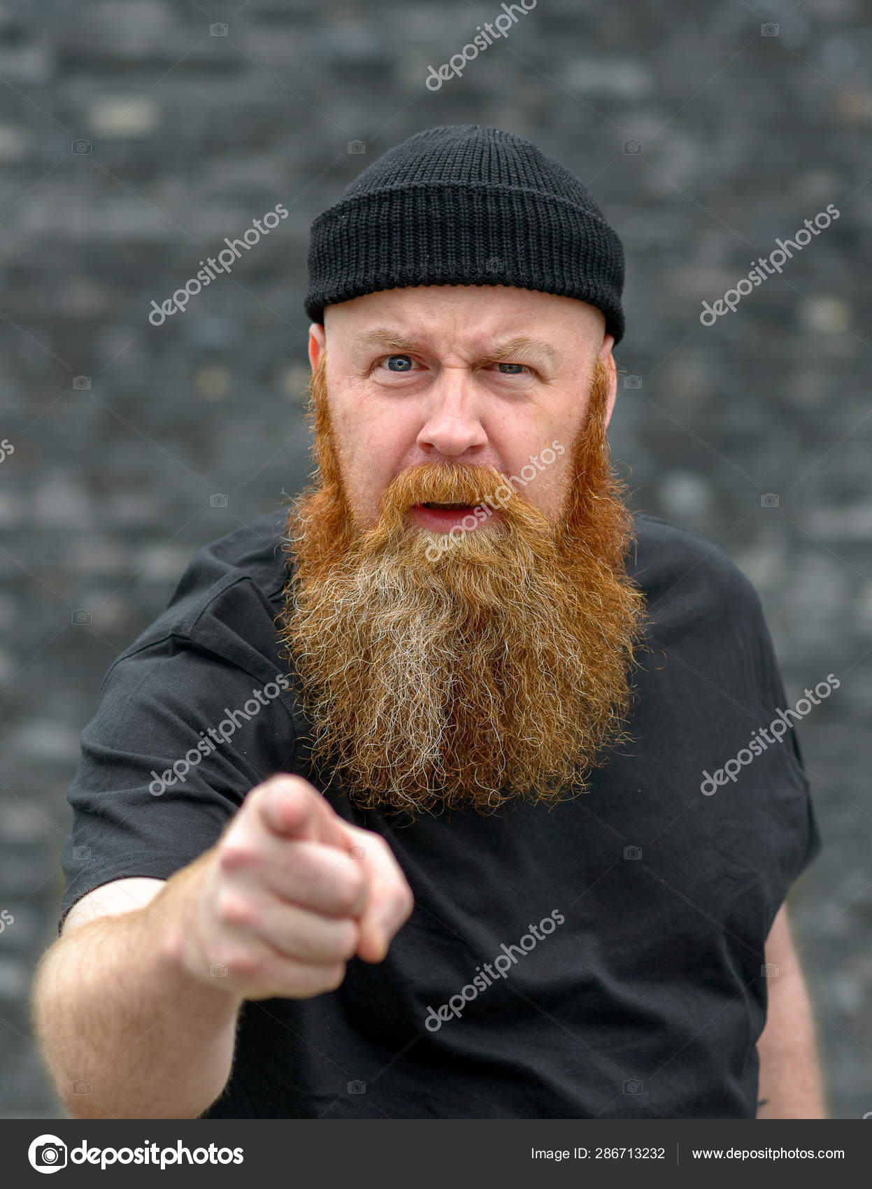 Bearded man pointing at the camera in disbelief — Stock Photo © info ...