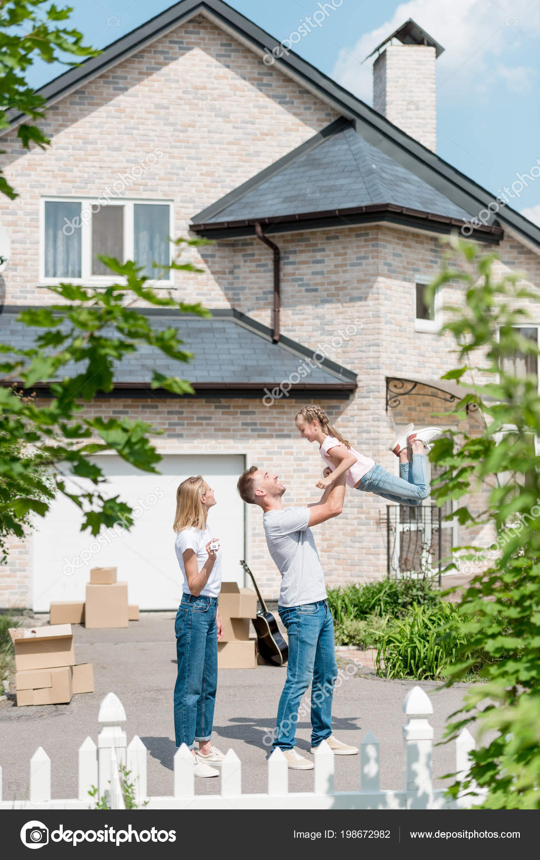 Side View Father Raising Daughter While Mother Standing Front New ...
