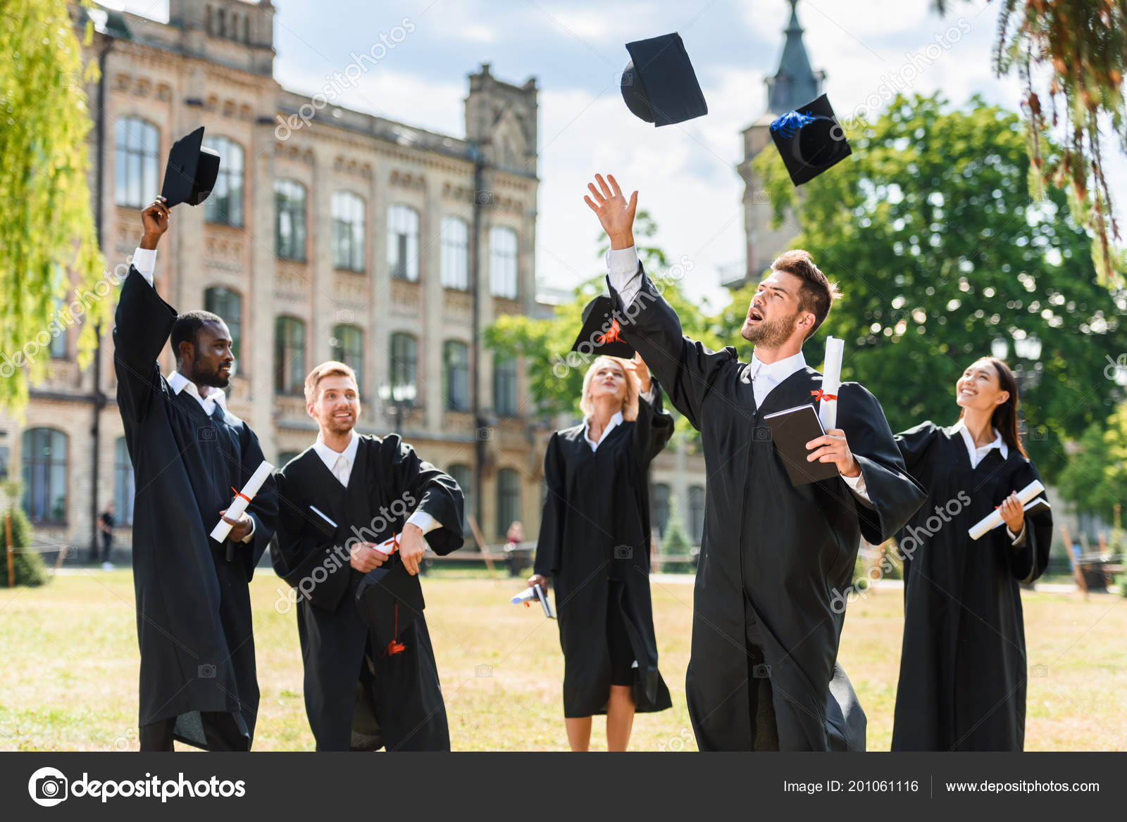 Young Happy Graduated Students Throwing Graduation Caps University ...