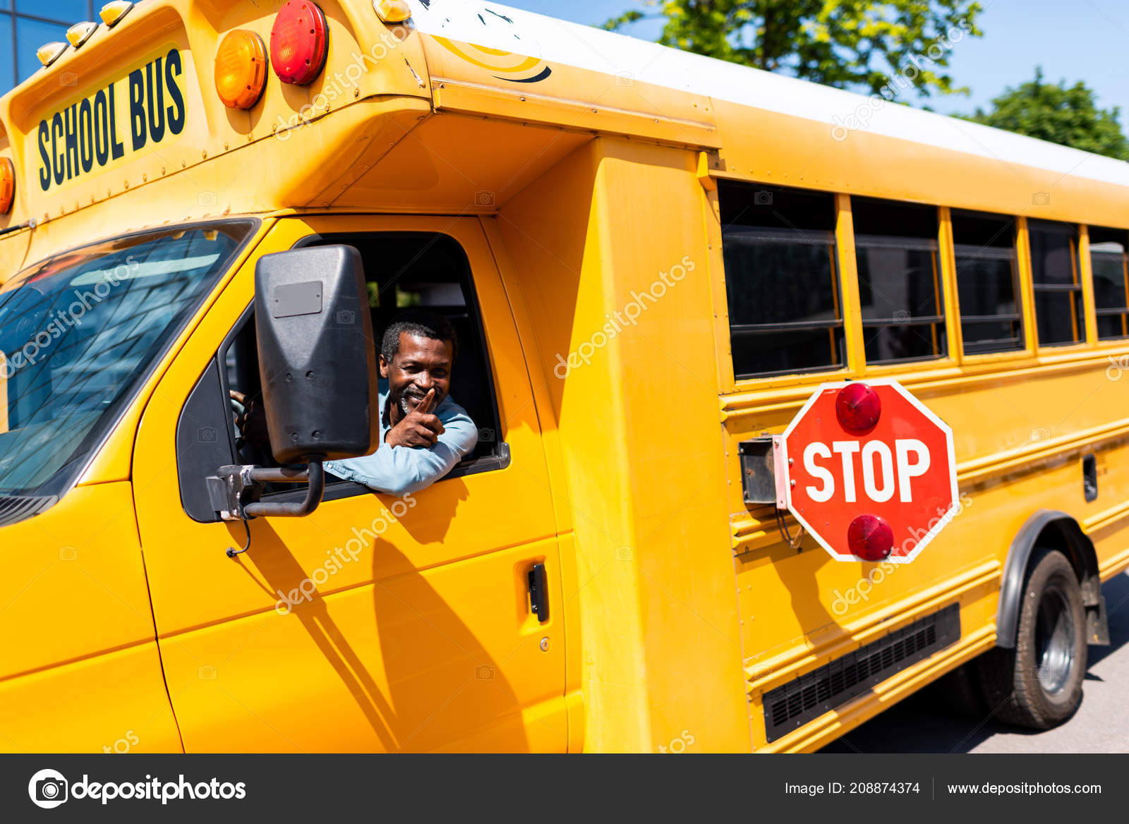 Smiling Mature African American Bus Driver Looking Out Window Gesturing ...