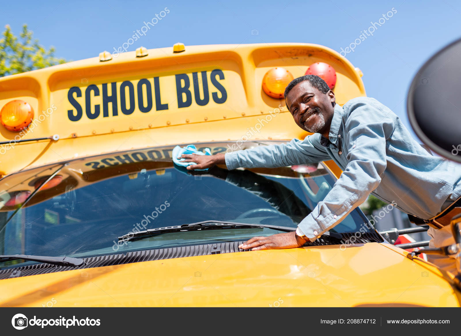 Smiling Mature African American Bus Driver Wiping Front Window School ...