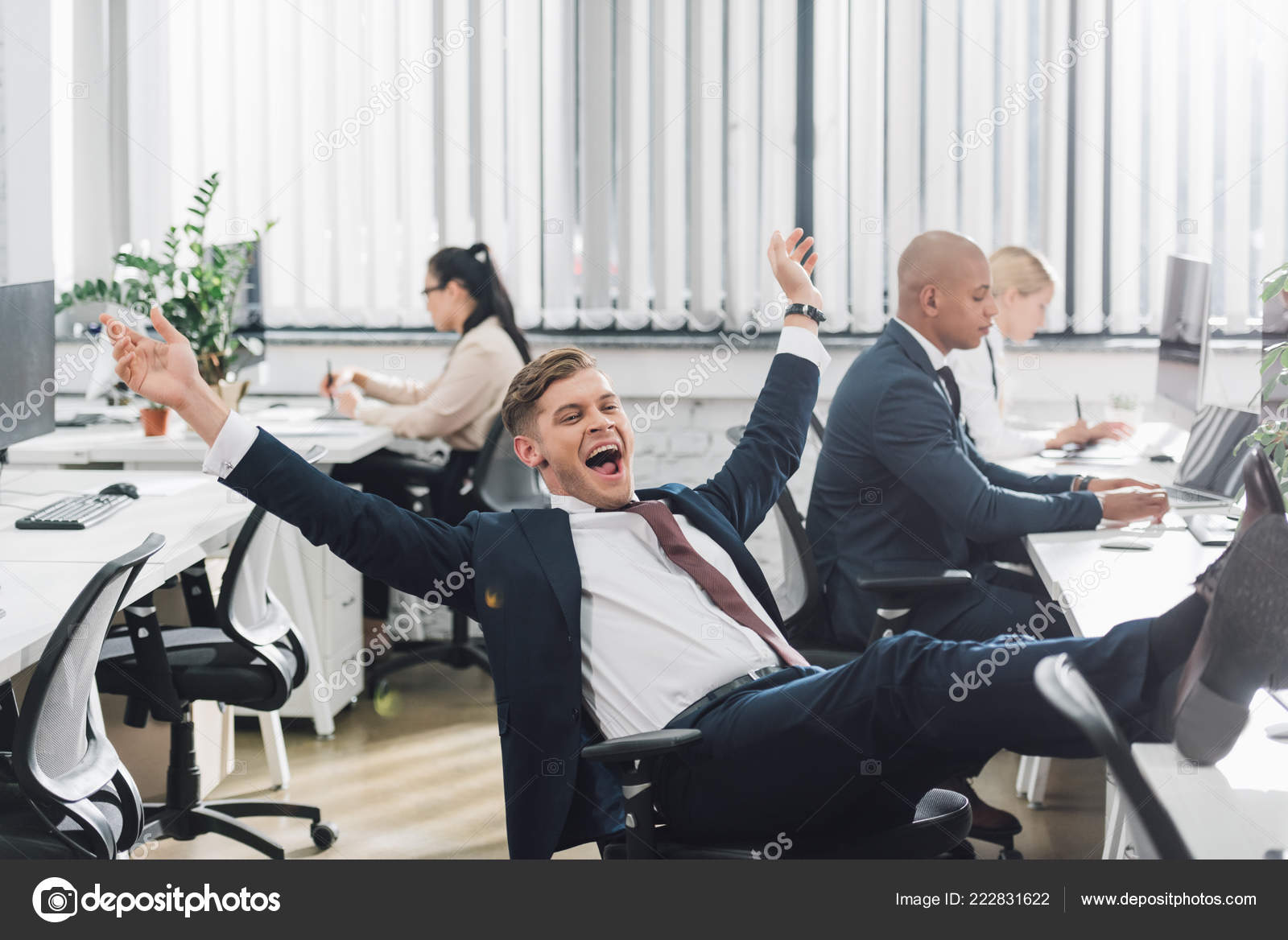 Excited Young Businessman Triumphing While Working Office Stock Photo ...