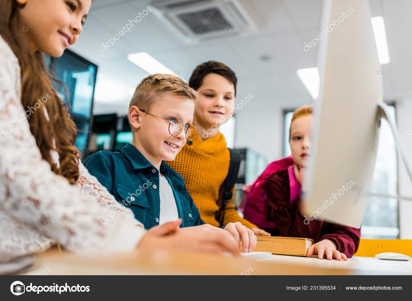 Adorable Smiling Schoolchildren Using Desktop Computer Library Stock ...