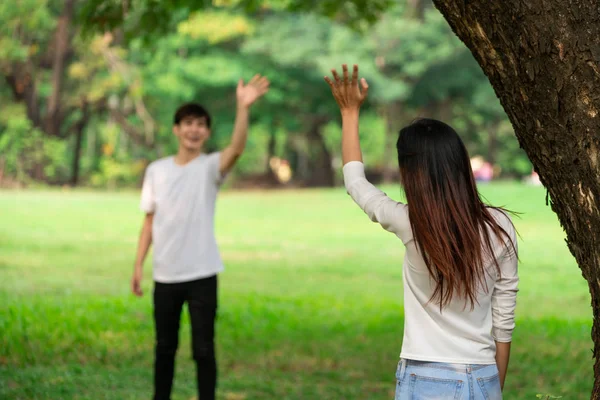 People greeting or saying goodbye by waving hands. - Stock Image - Everypixel