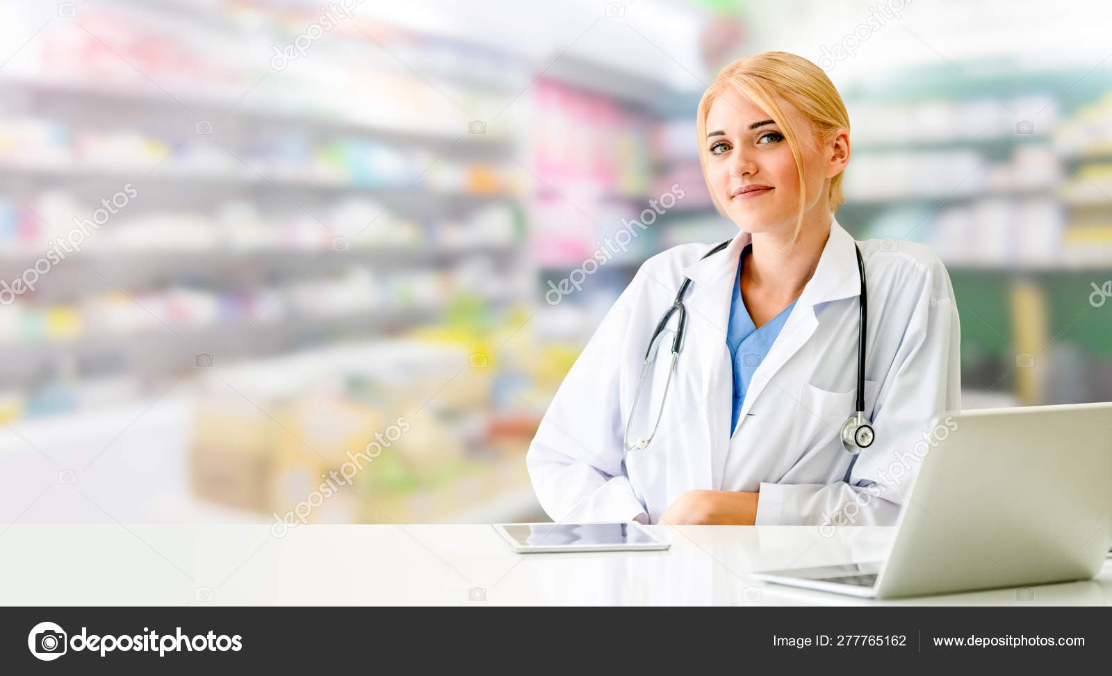 Pharmacist using laptop computer at pharmacy. — Stock Photo ...