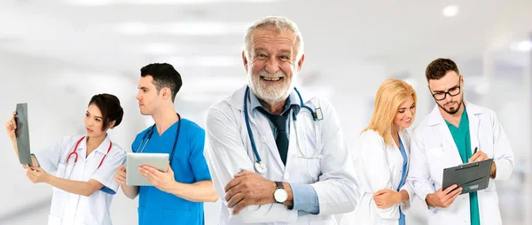 Doctor working in hospital with other doctors. - Stock Image - Everypixel