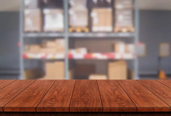 Wood table in warehouse storage blur background. - Stock Image - Everypixel