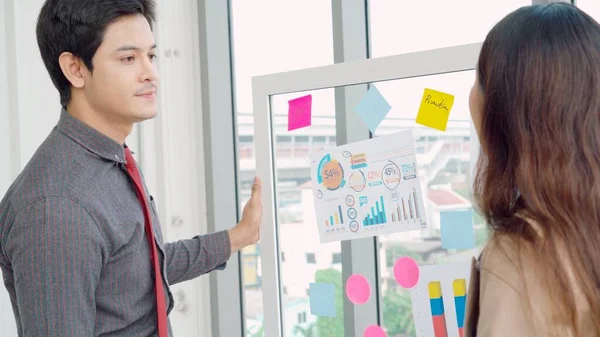 Business people work on project planning board in office and having ...