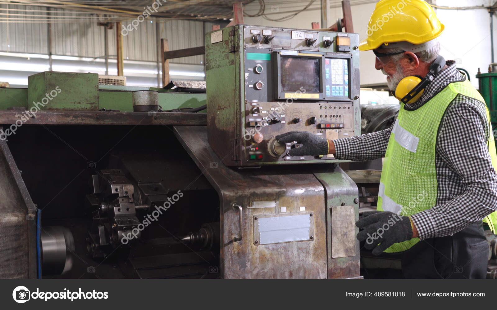 Smart factory worker using machine in factory workshop Stock Photo by ...
