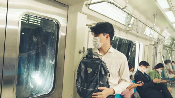 Crowd of people wearing face mask on a crowded public subway train ...
