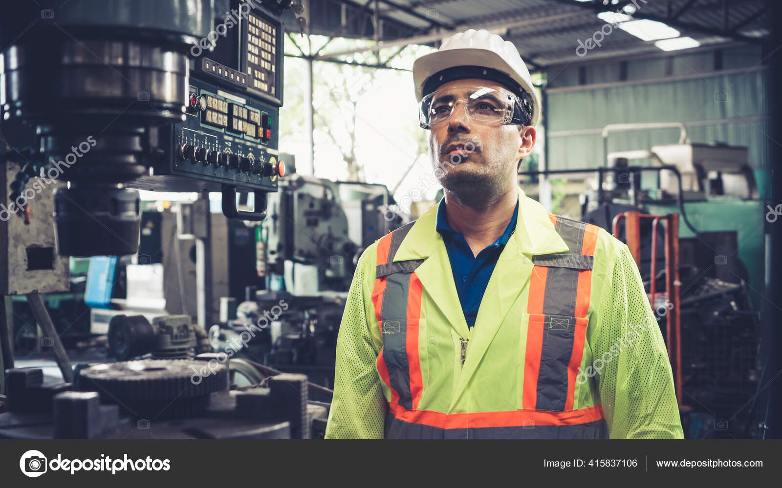 Smart factory worker using machine in factory workshop Stock Photo by ...