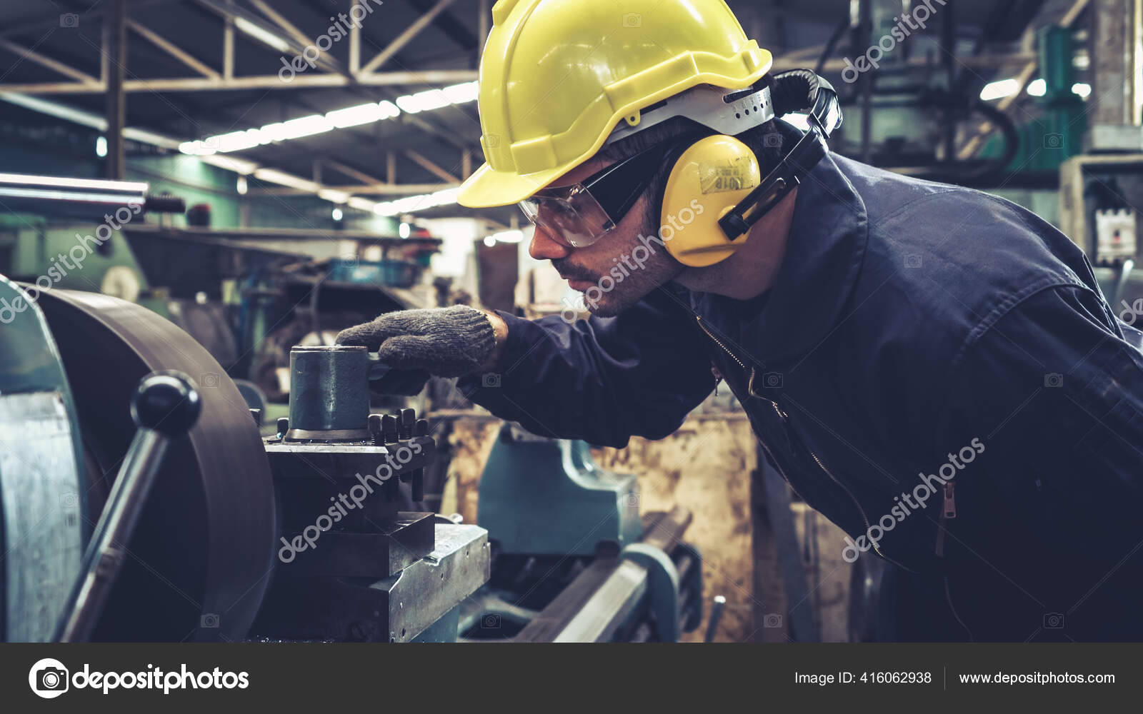 Smart factory worker using machine in factory workshop Stock Photo by ...