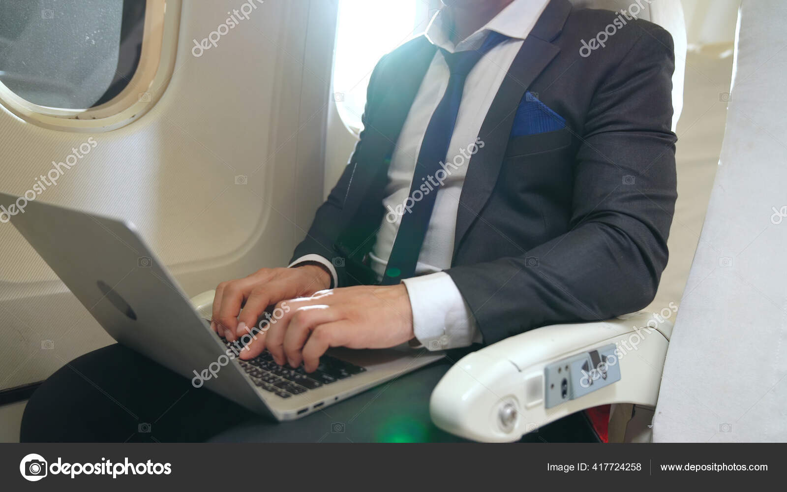 Young businessman using laptop computer in airplane — Stock Photo ...