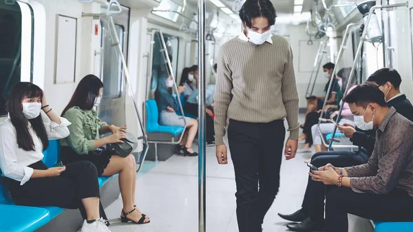 Crowd Of People Wearing Face Mask On A Crowded Public Subway Train