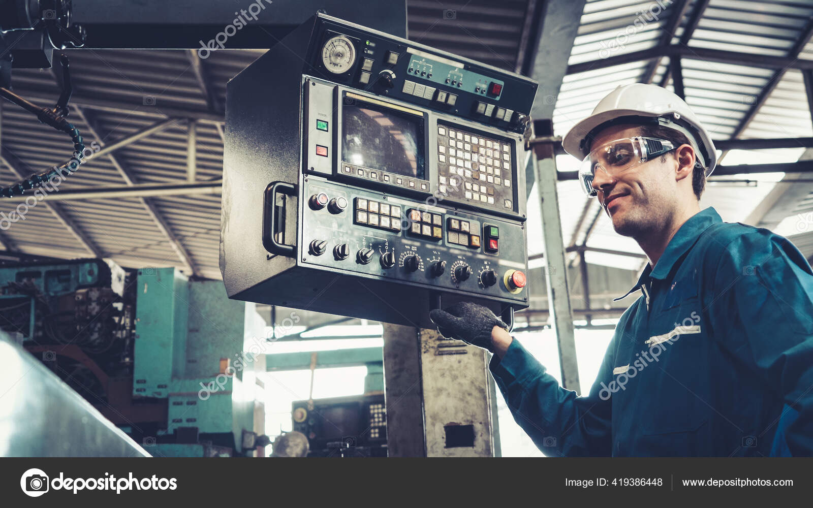 Smart factory worker using machine in factory workshop Stock Photo by ...